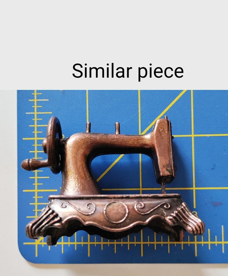 A Coppery Miniature Metal Sewing Machine Was Made in Hong Kong as an ...