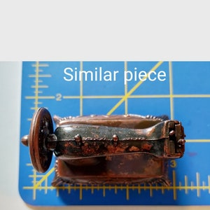 A Coppery Miniature Metal Sewing Machine Was Made in Hong Kong as an ...