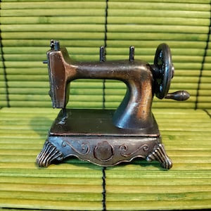A Coppery Miniature Metal Sewing Machine Was Made in Hong Kong as an ...