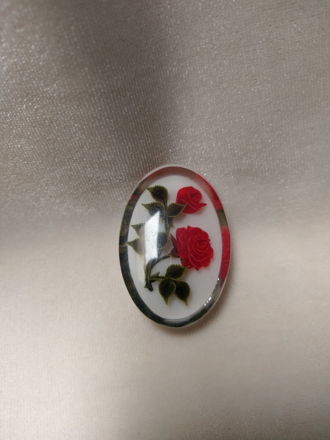 Vintage Clear Oval Lucite Brooch With Embedded Roses on a White Lucite ...