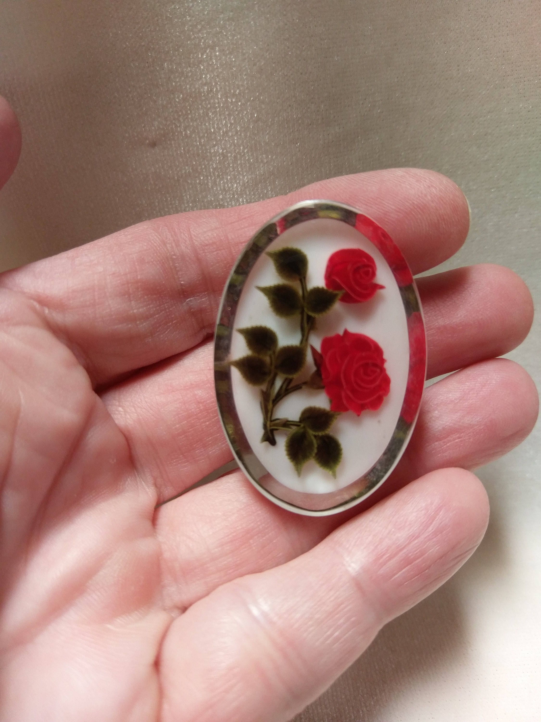 Vintage Clear Oval Lucite Brooch With Embedded Roses on a White Lucite ...