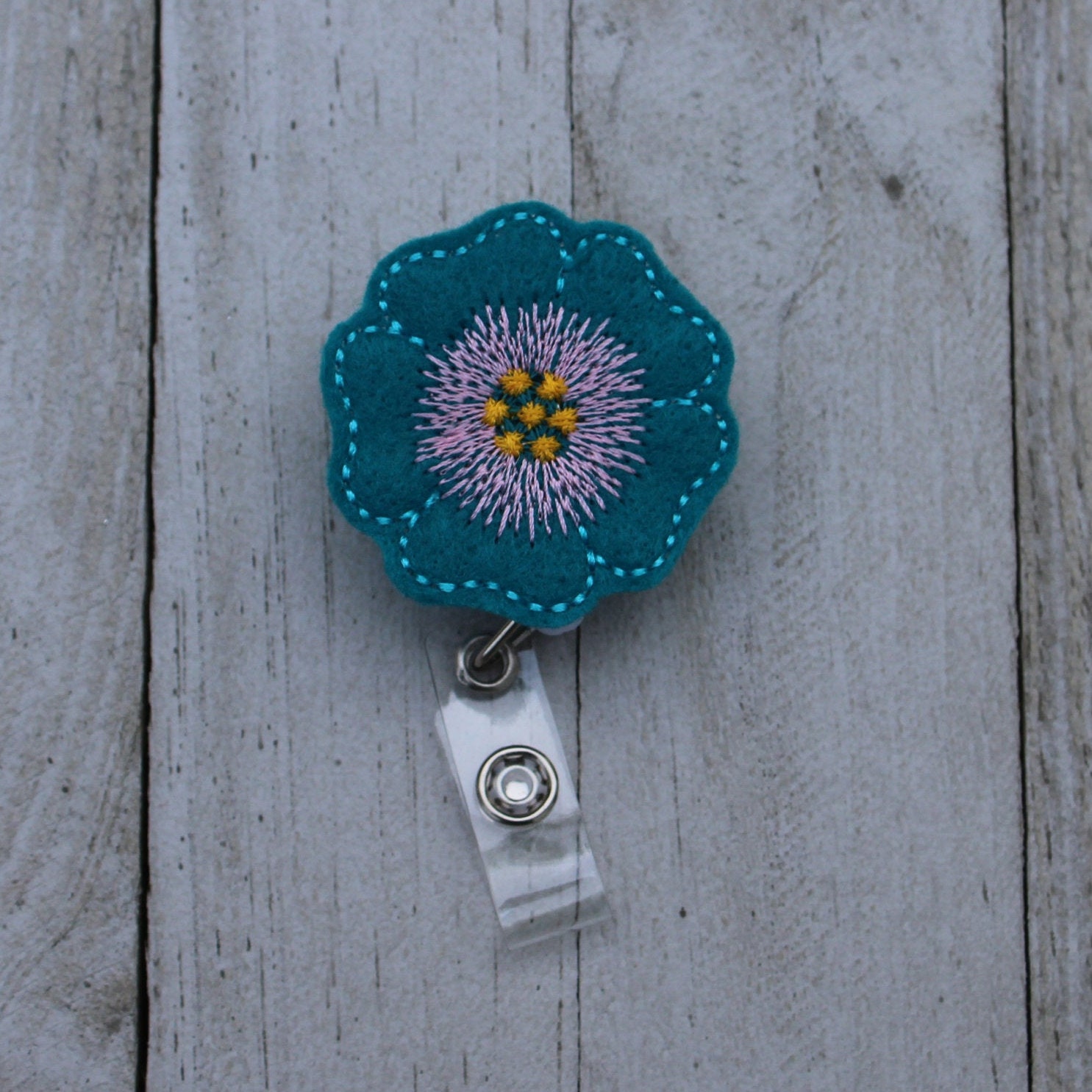 Flower retractable ID badge holder. Flower retractable ID badge holder.