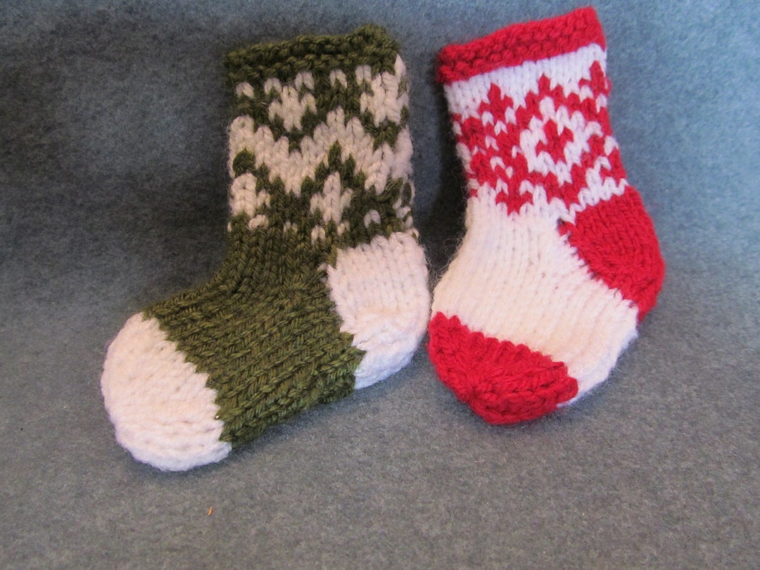 Two Different Colored Holiday Stockings, One Red and White and One ...