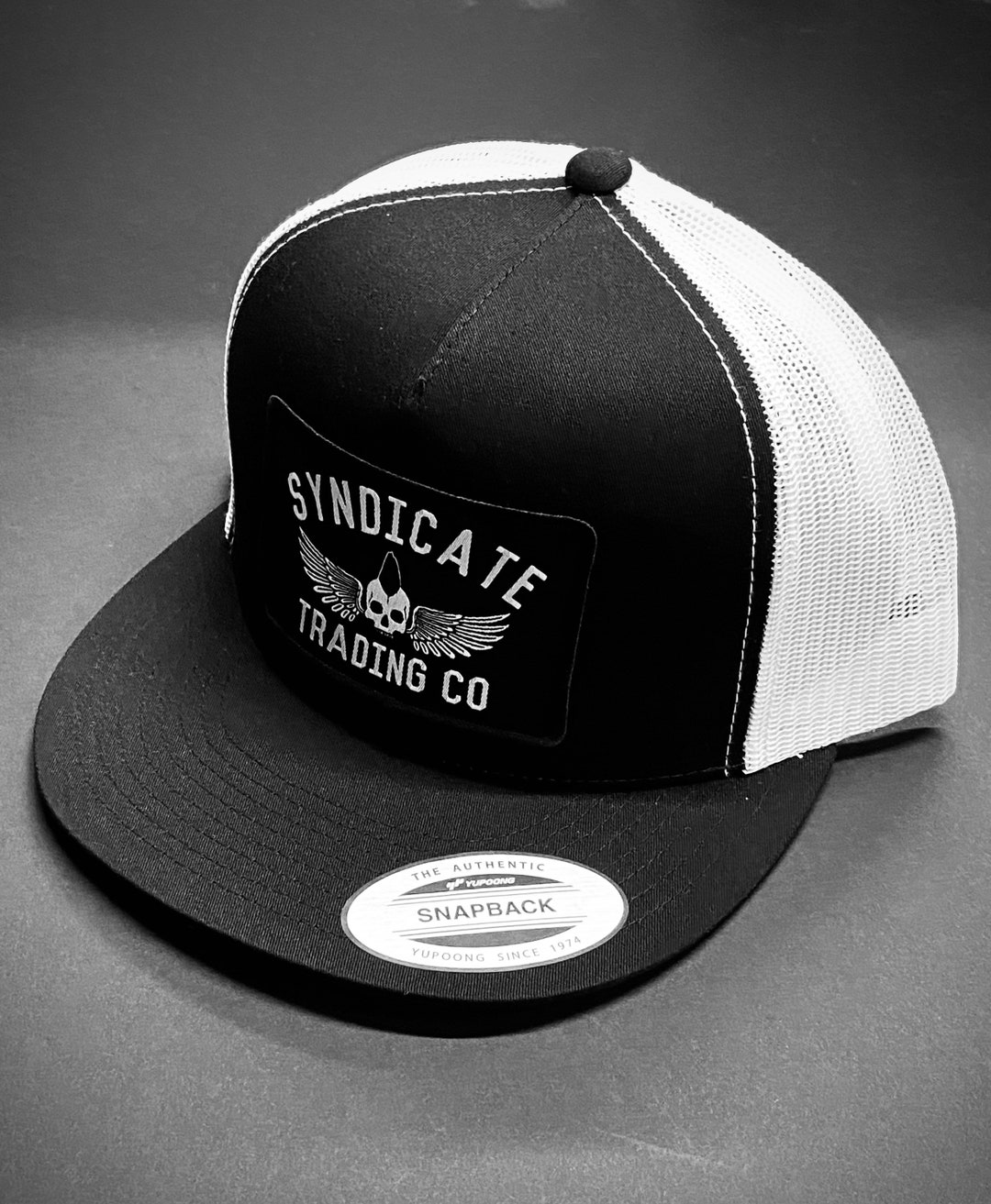 Syndicate Trading Co Winged Skull Patch Flat Bill Trucker Hats in ...