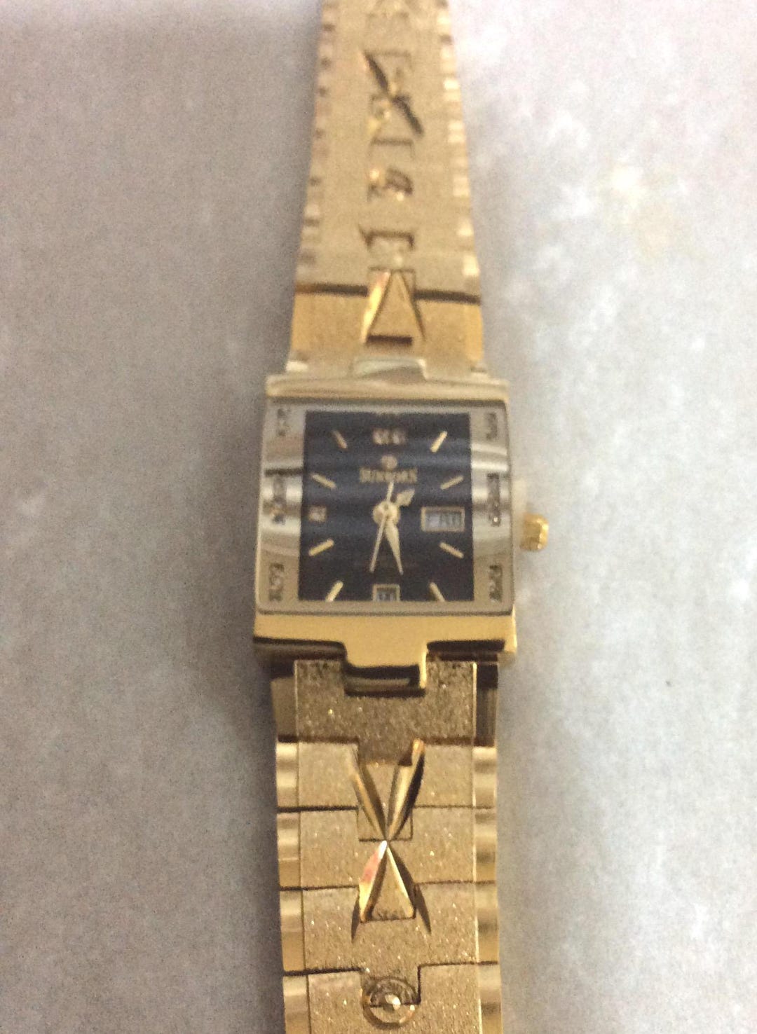 SUNBORN Women's Gold Crystal Watch Having a Rectangle Black Dial Gold ...