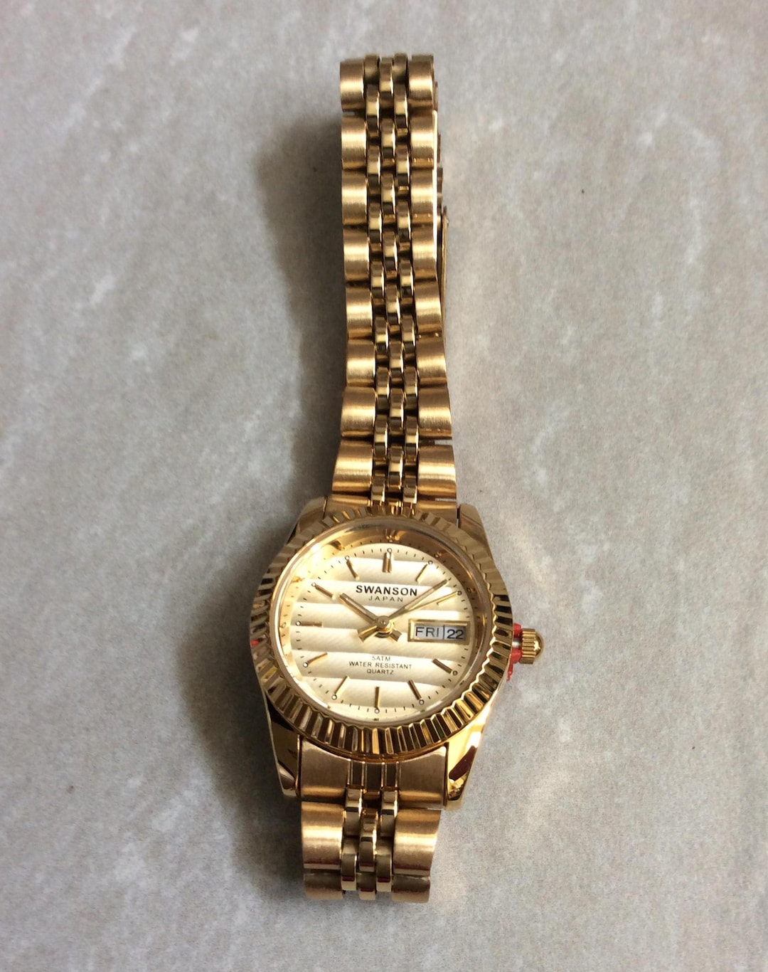 SWANSON Women's Gold Watch Having a Round Gold Dial Index Hours and Day ...