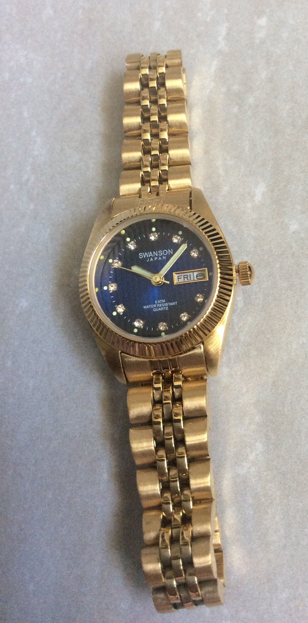 SWANSON Waterproof 5ATM Women's Gold Watch Having a Round Blue Dial ...