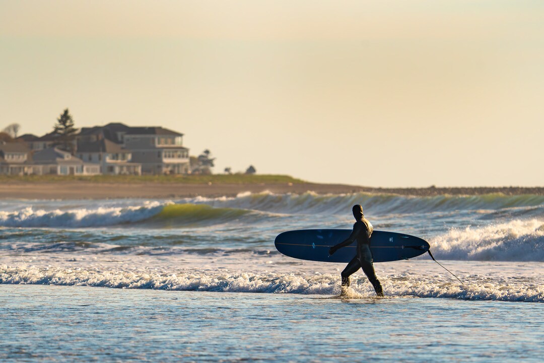 Cold Water Surfer With Long Board Walking Out of Water on New England ...