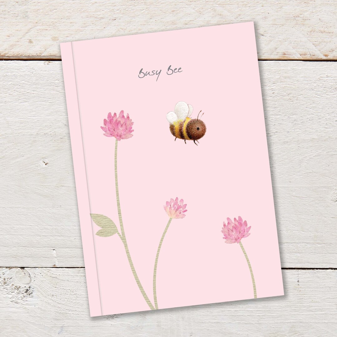 A6 96pp Notebook Featuring a Cute Busy Bee and Pink Clover Flowers on a ...