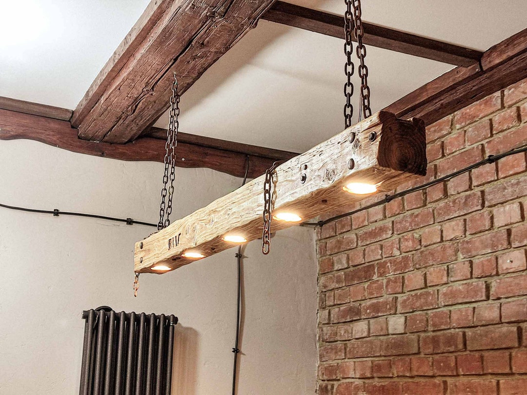 Long Wooden Beam Lamp Hanging on Chains in Rustic Style. Natural Light ...