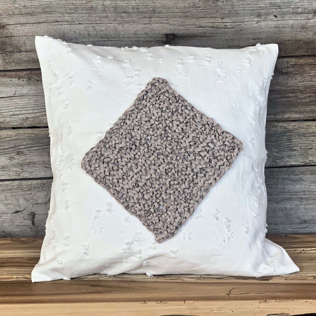 White Cushion in Ripped Look With Sewn-on Route Made of Beige Ribbon ...