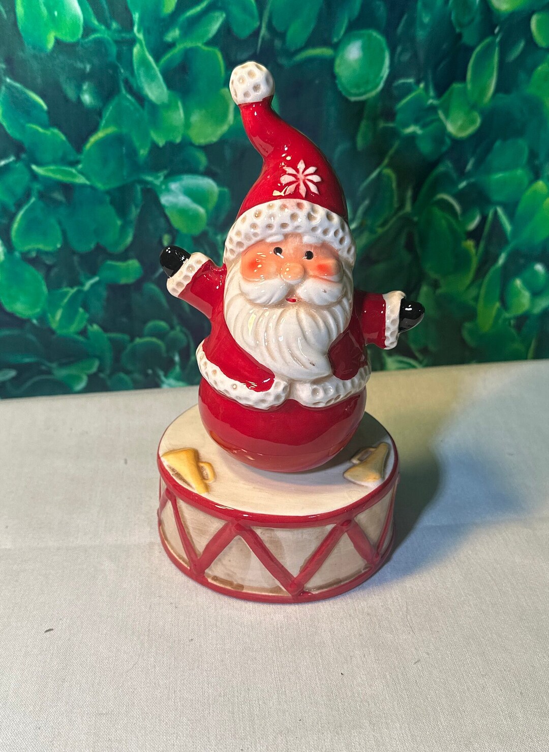 Santa Rockint to a Music Box Rotating on a Drum Like Stage to “ We Wish ...