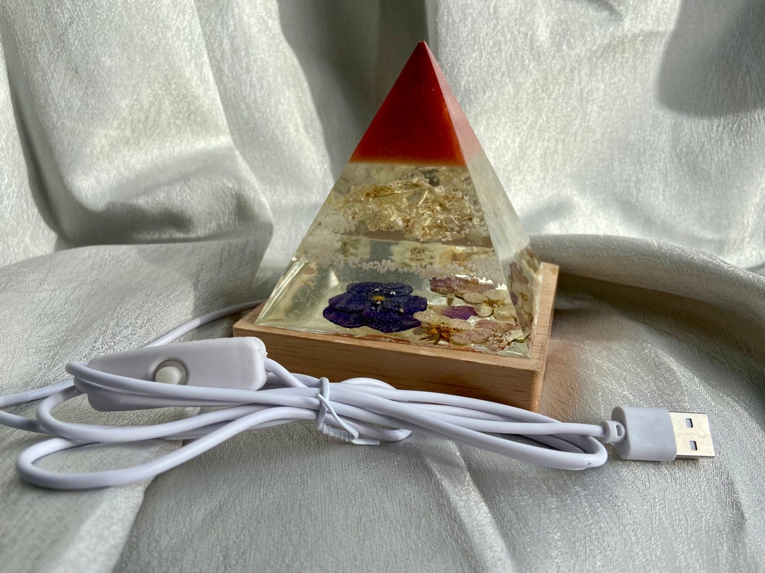 Pyramid-shaped Lamp Made of Epoxy Resin, Flowers and Light on a Wooden ...