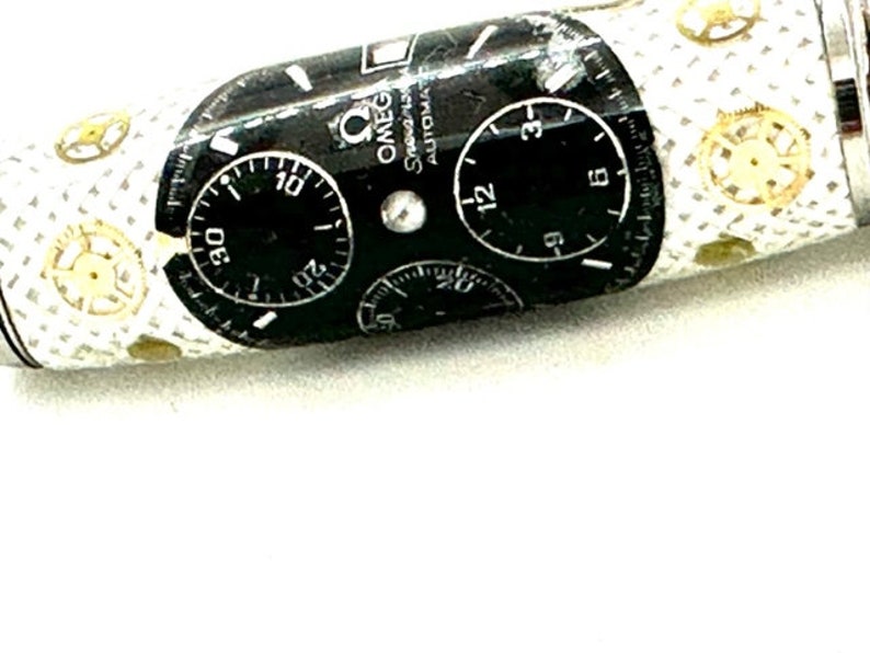 Black Omega Watch Dial With Watch Parts With White Carbon Fiber on a ...