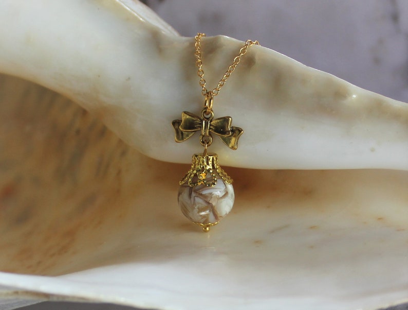 White and Cream Picasso Swirl Sphere With a Dainty Bow Gold Necklace - Etsy