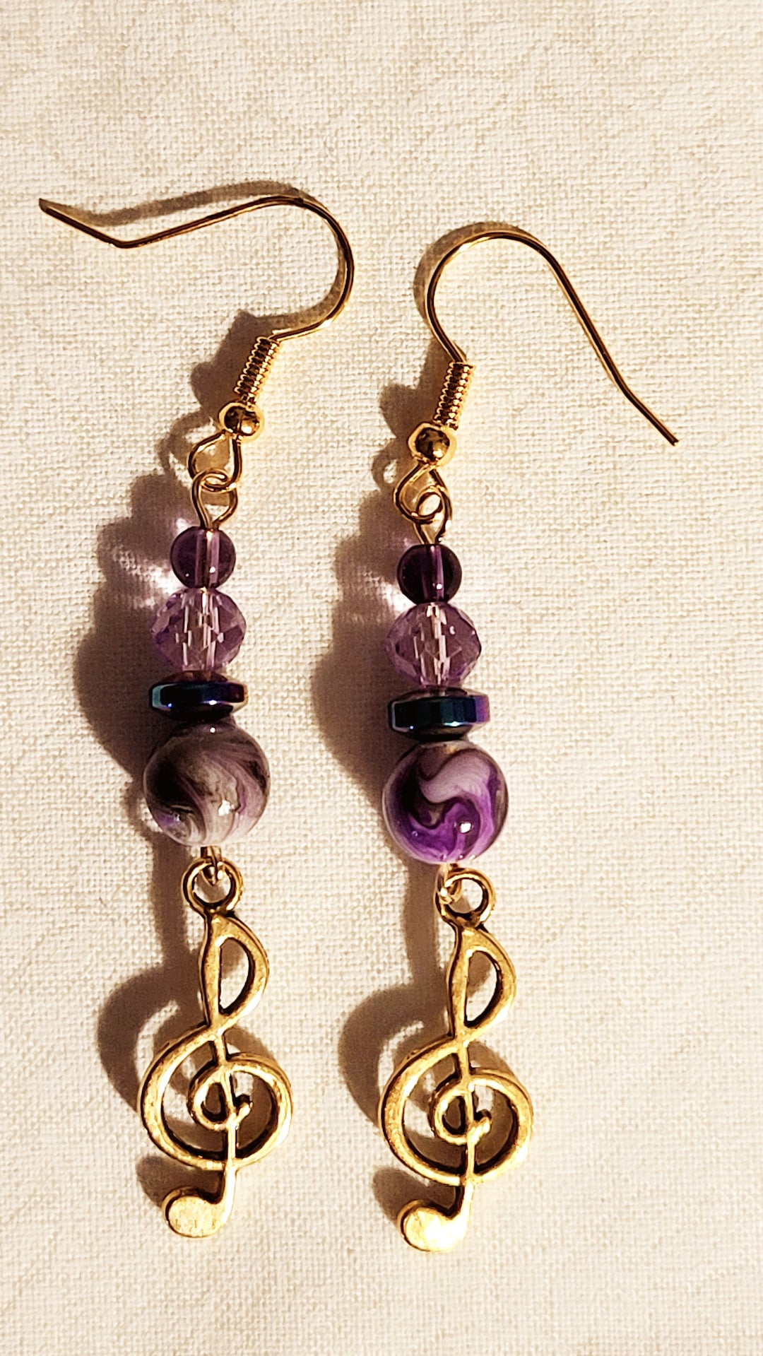 221 Golden Treble Clefs Dangle From Distinctive Purple Beads in ...