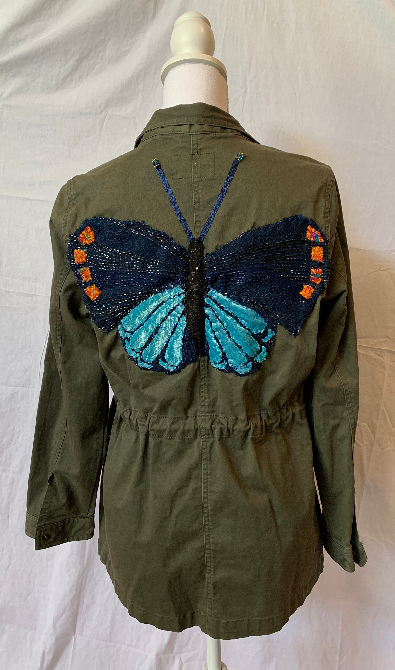 Art on Army Green Jacket. Blue Butterfly Art Created With Recycled ...