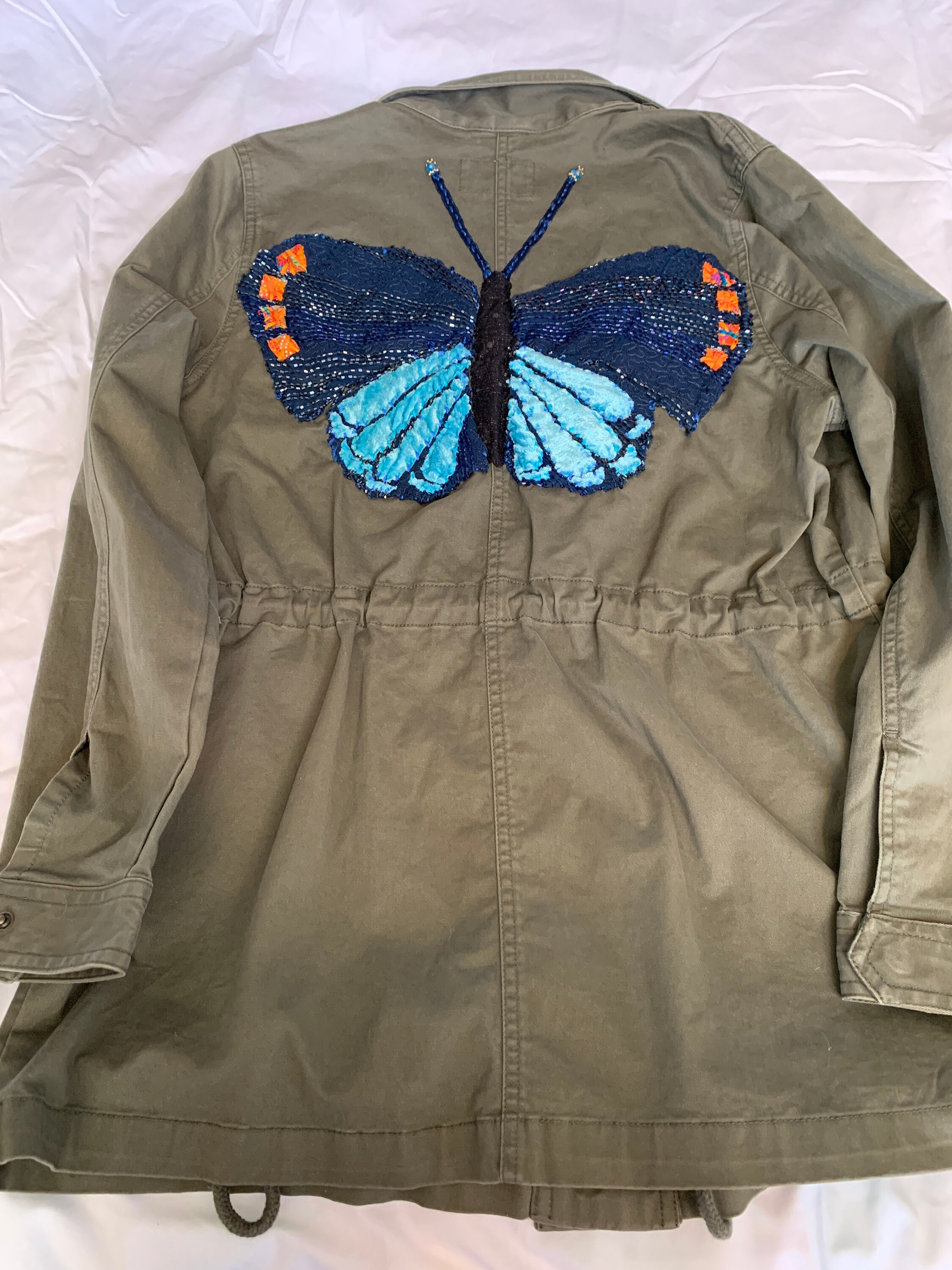 Art on Army Green Jacket. Blue Butterfly Art Created With Recycled ...