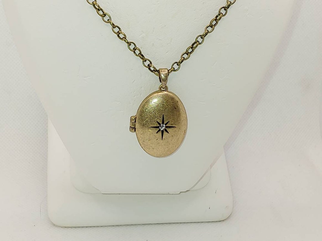 Antique Gold Finish Oval Locket With a Star Engraved on the Front and a ...