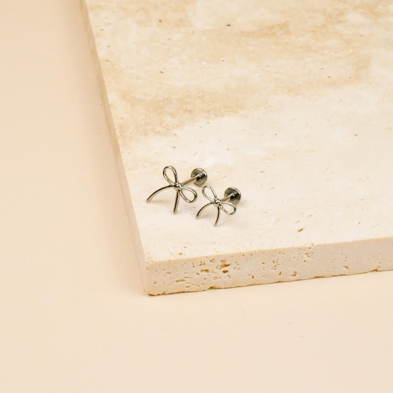 Dainty Ribbon Bow Knot Tie Stud Earrings · Titanium Flatback Earrings · Cartilage Stud Earrings ...