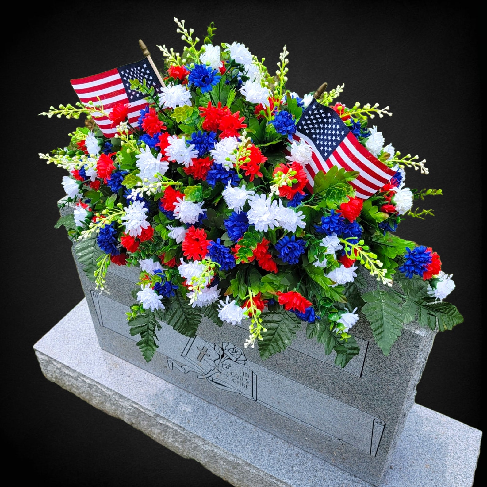 This Headstone Saddle Has Grave Flowers Including Red, White, & Blue ...