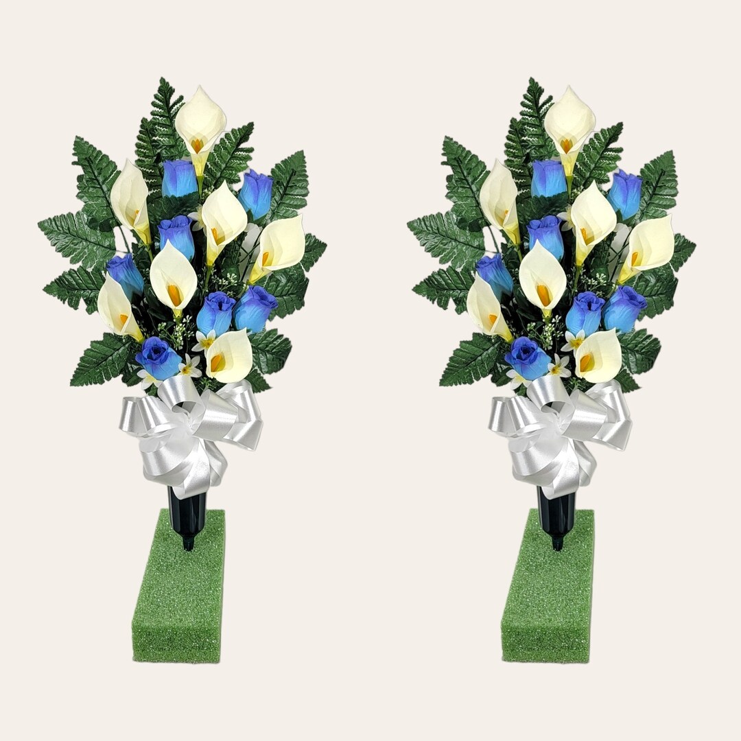 This Cemetery Cone Pair Has Grave Flowers Including Baby Blue Rosebuds ...