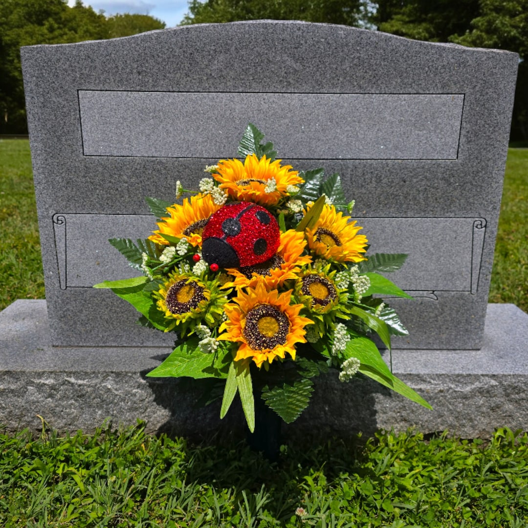A Cemetery Cone Has Grave Flowers Including Yellow Sunflowers and a ...