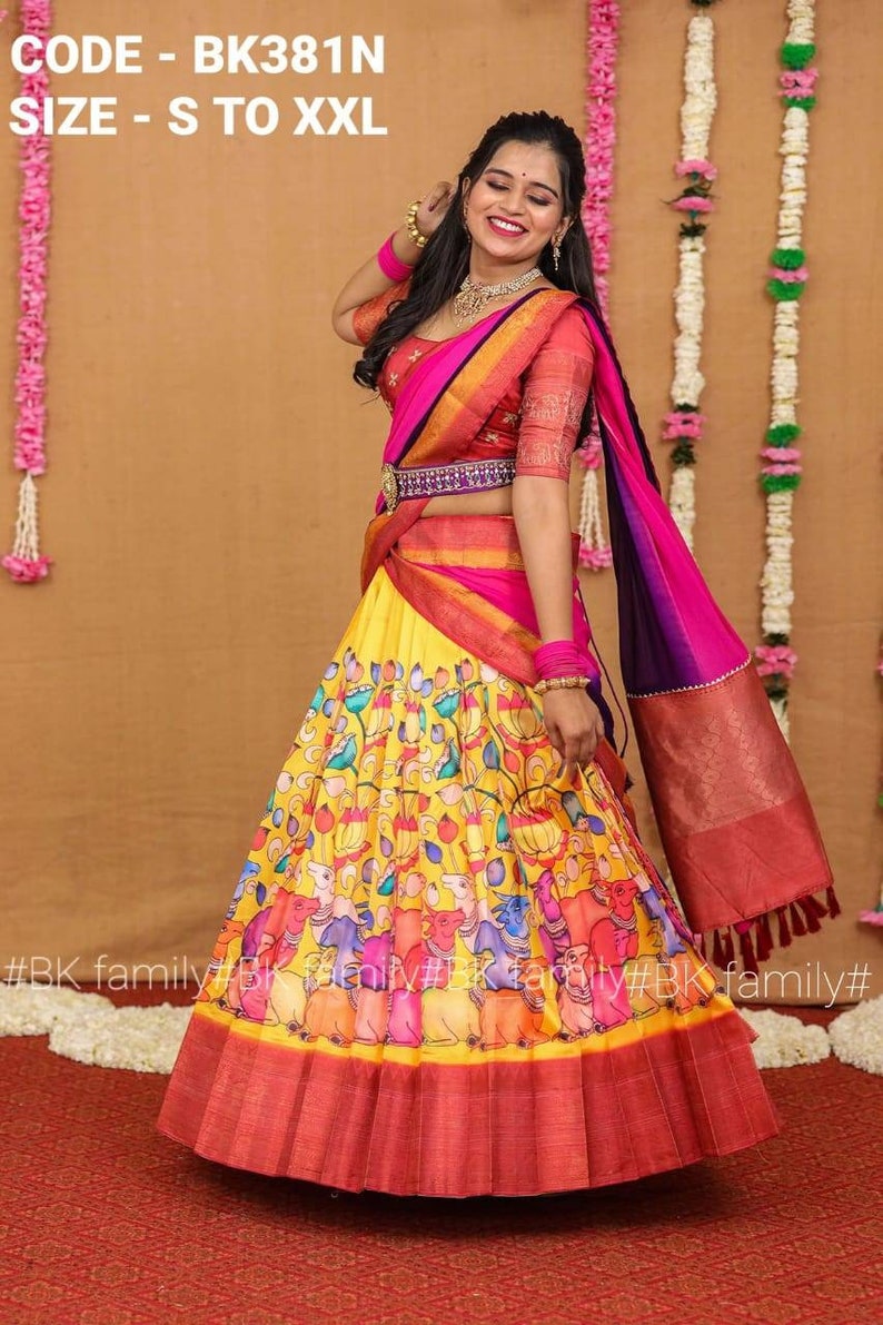 Charming Yellow Kalamkari Half Saree Paired With Purpal and Rani Pink ...