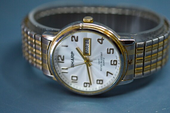 Sharp, silver and gold tone, stretch bracelet, quartz… - Gem