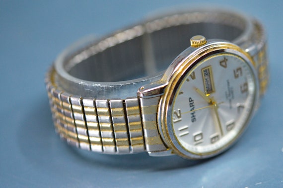 Sharp, silver and gold tone, stretch bracelet, quartz… - Gem