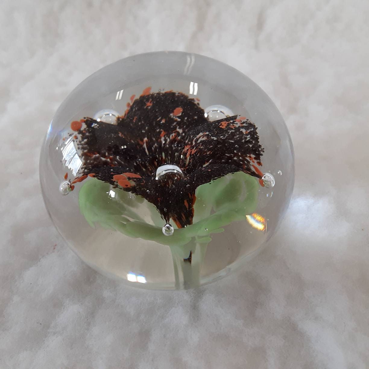 Round Glass Paperweight With Black and Orange Flower and Green Stems ...