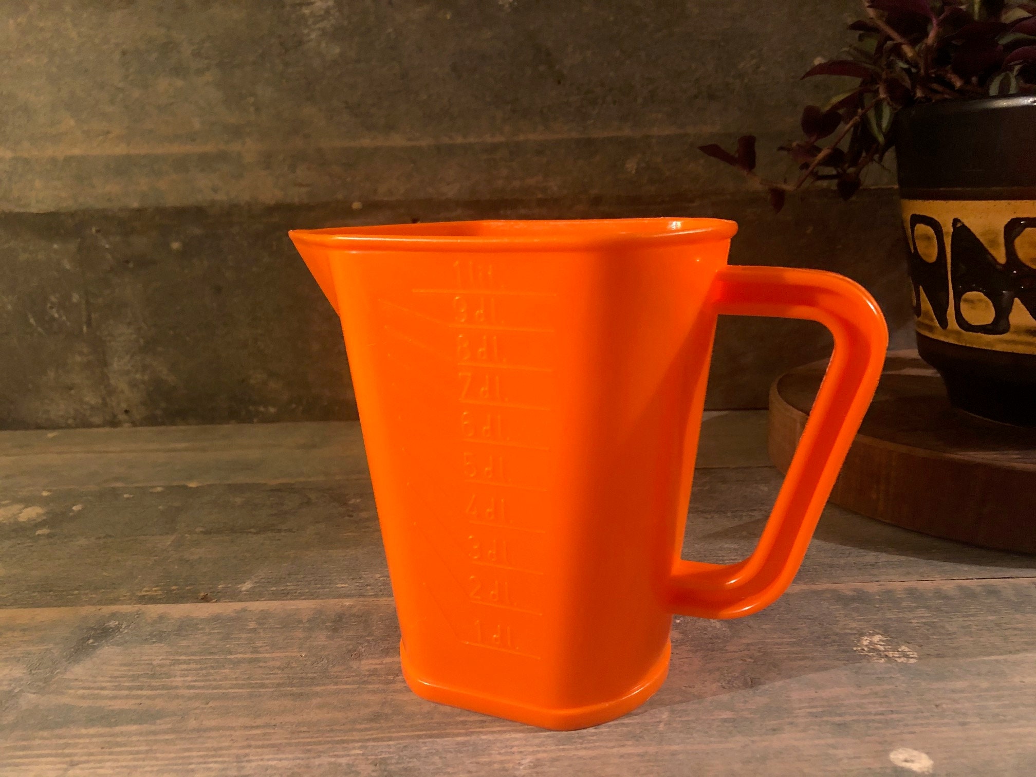 Vintage plastic measuring cup, retro measuring jug, bright orange ...