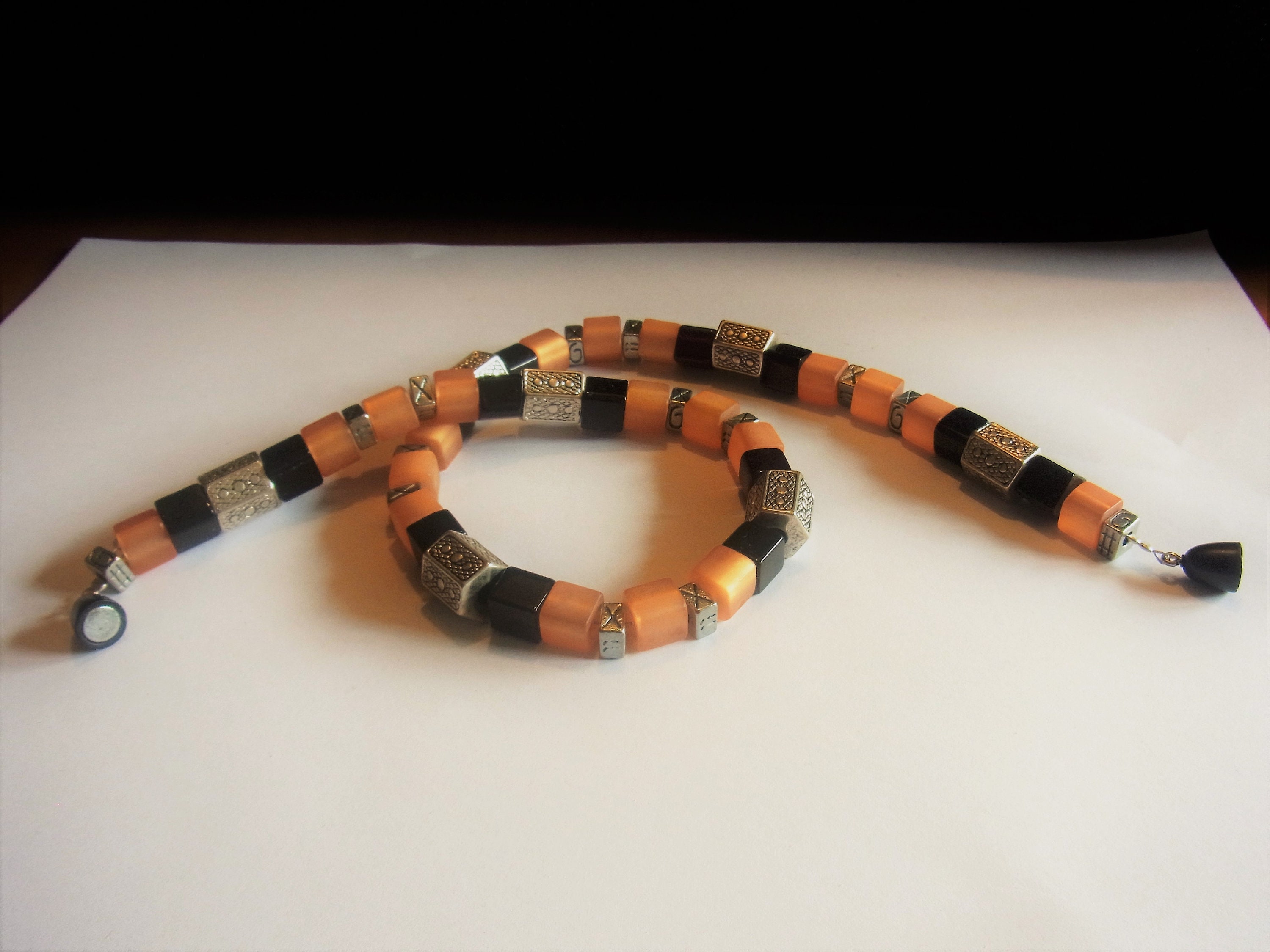 Discreet Necklace peach Peach-colored Polaris and Black Glass Cube ...