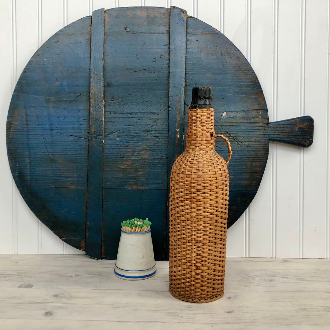Vintage Wicker Wrapped Demijohn Bottle With Handle With an Old Interior ...