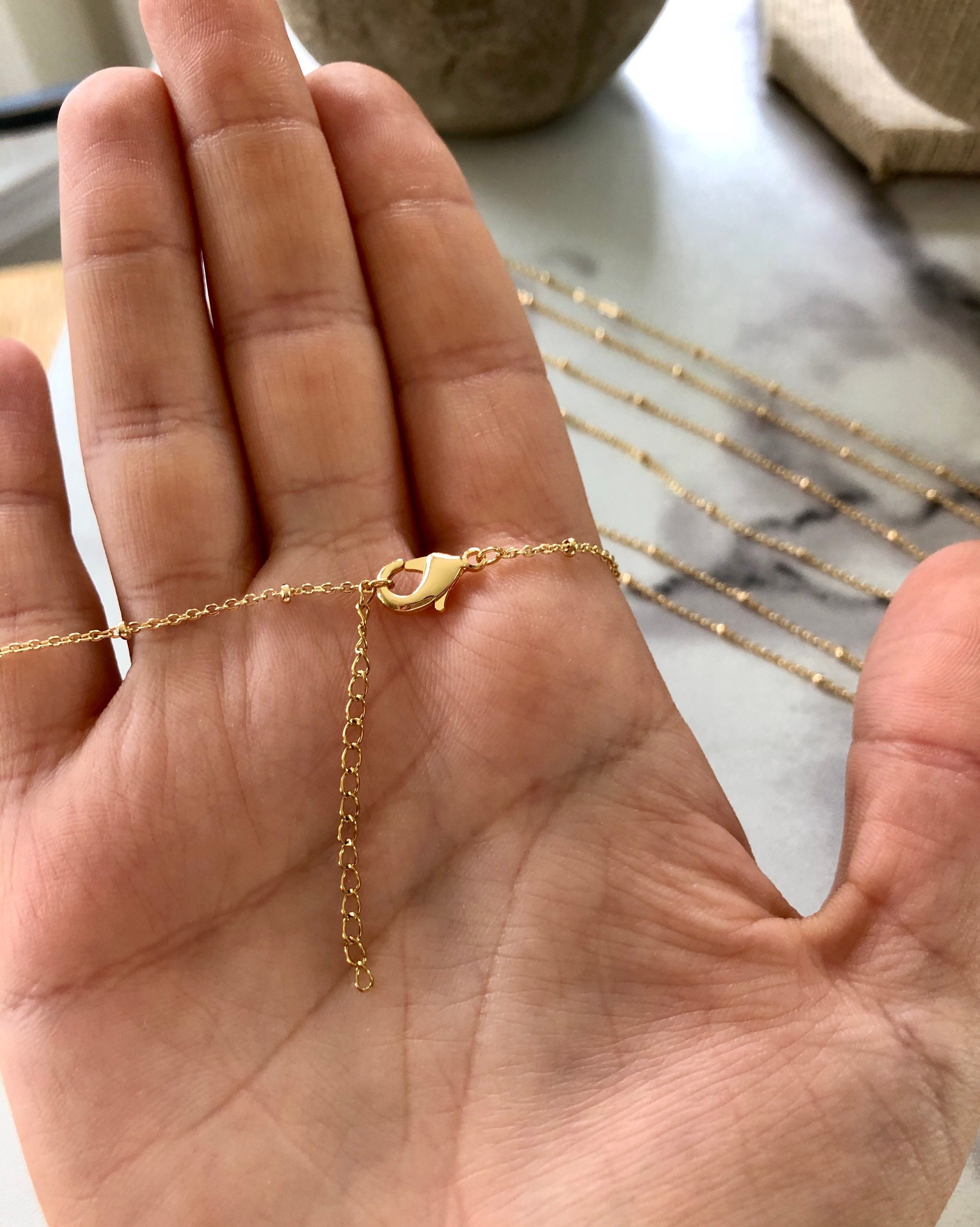 Gold evil eye coin with rainbow gems necklace