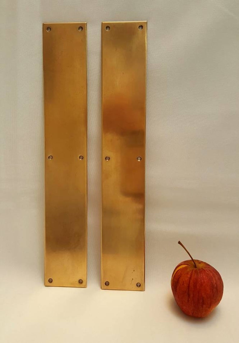 Pair of English late Victorian twelve inch plain solid brass finger ...