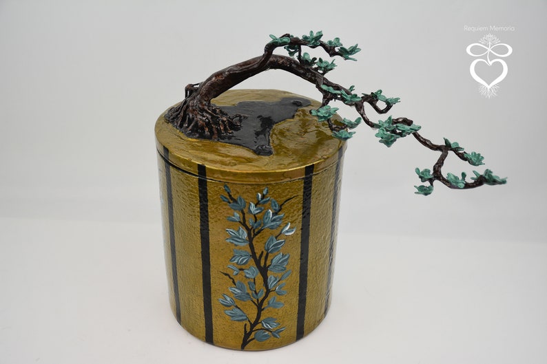 Unique and artistic cylindrical urn gold and black in color - Etsy.de