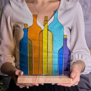 Colorful Bottles Stained Glass Table Stand on the Wooden Platform ...