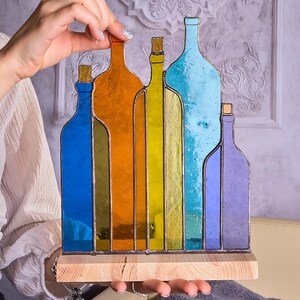 Colorful Bottles Stained Glass Table Stand on the Wooden Platform ...