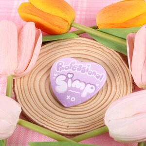 Professional Simp, Holographic Heart Shaped 57mm Button Badge Ionzy's ...