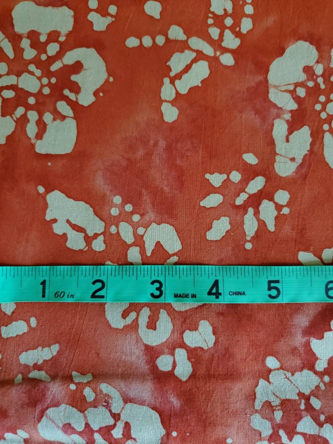 Batik, Abstract Beige Pebbles and Flowers Scattered on a Rust, Terra ...