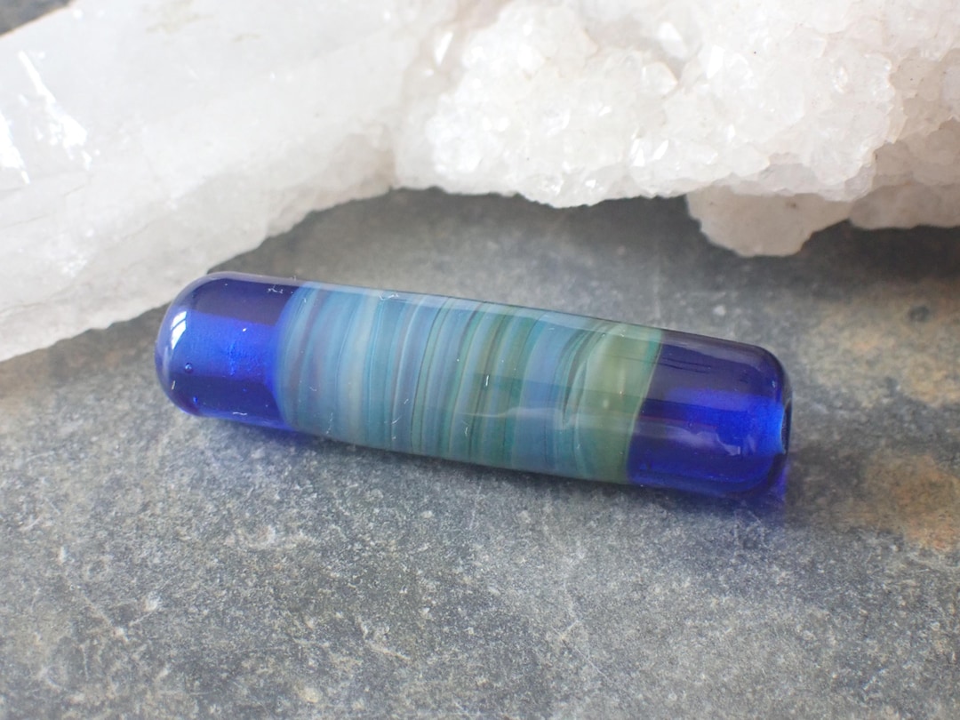 A Medium Blue Clear Transparent Tube Focal Bead With Shiny Blue Ribbons ...