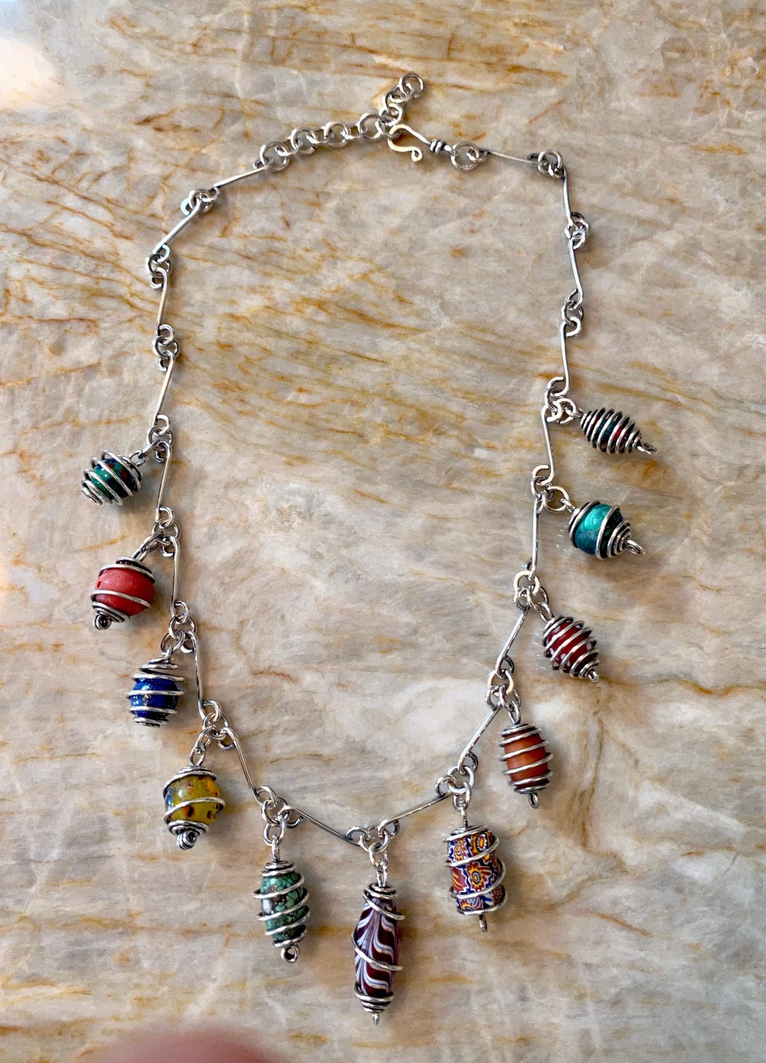 A Necklace Made With Wire Wrapped Beads. Some of the Beads Are From the ...