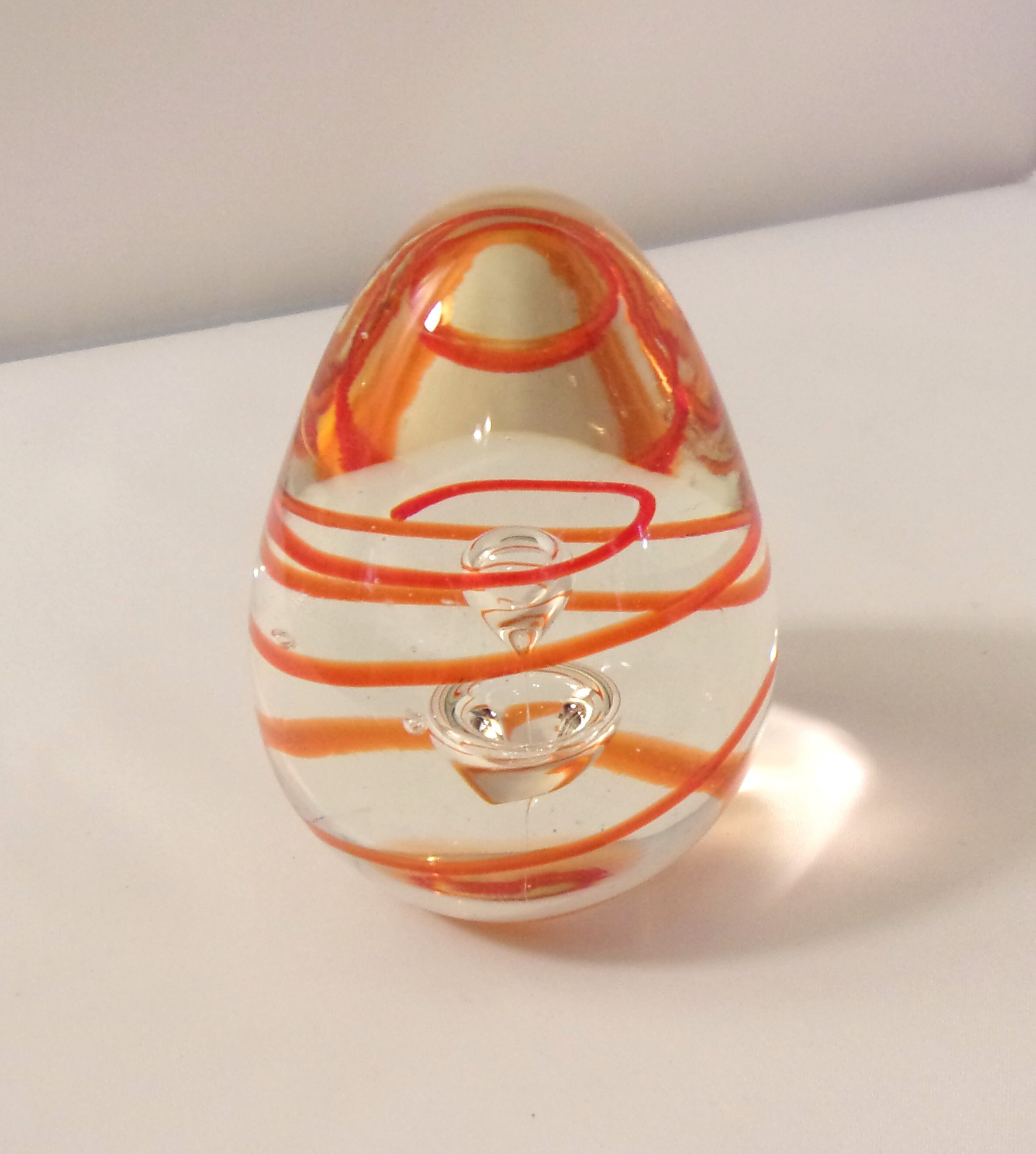 Oval Ovoid Shaped Paperweight With Orange Swirl Pattern Through Clear ...