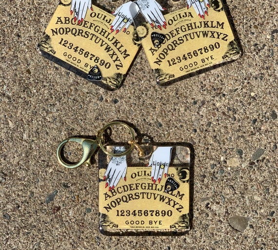 Mini Ouija board keychain layered with hands sealed with | Etsy