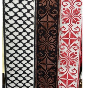 An Embroidered Bag Strap With A Traditional or Geometric Pattern ...