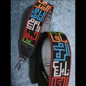 An Embroidered Bag Strap With A Traditional or Geometric Pattern ...