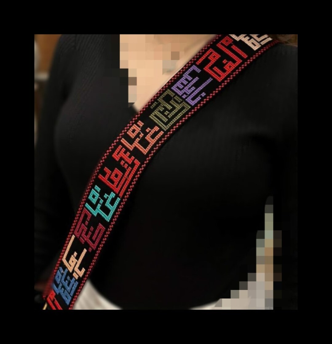 An Embroidered Bag Strap With A Traditional or Geometric Pattern ...