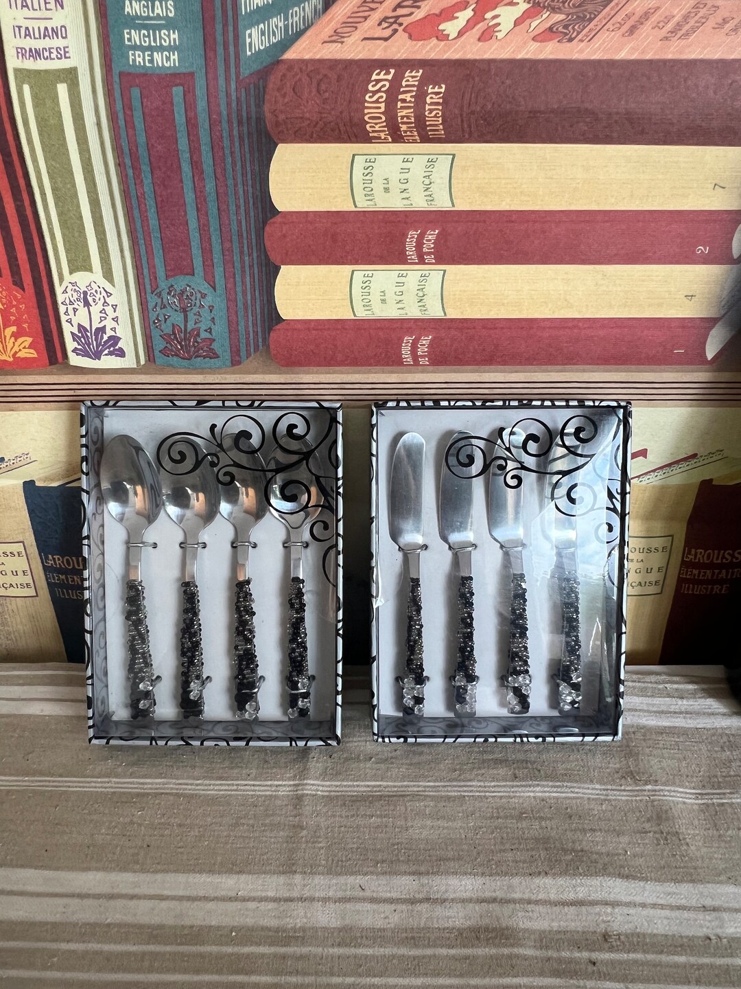 A Boxed Set of Four Wild Eye Designs Jewelled Spoons and Spreader Sets ...
