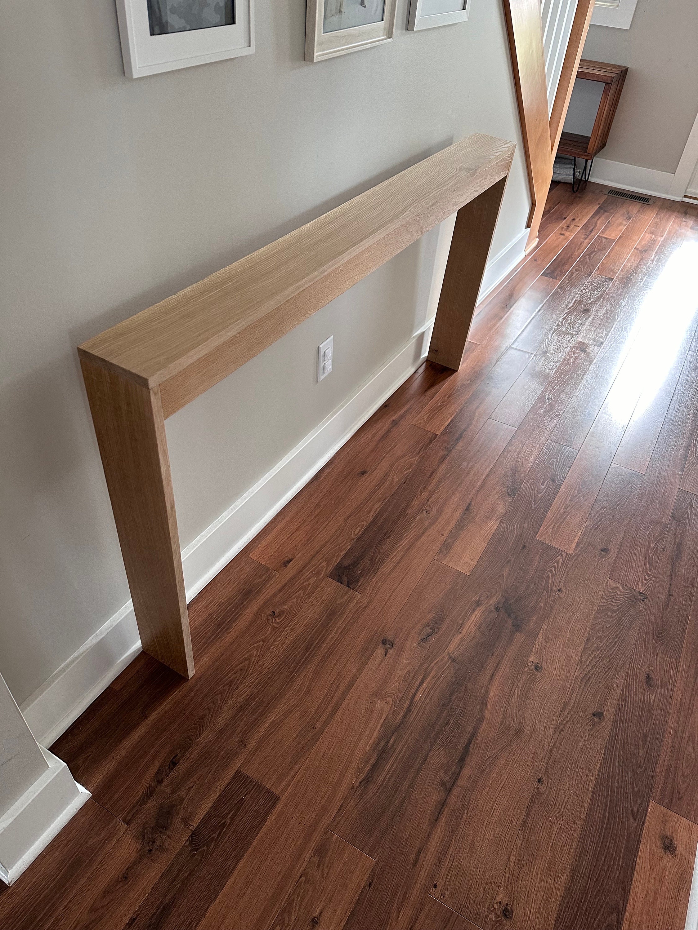 Low console table behind couch store